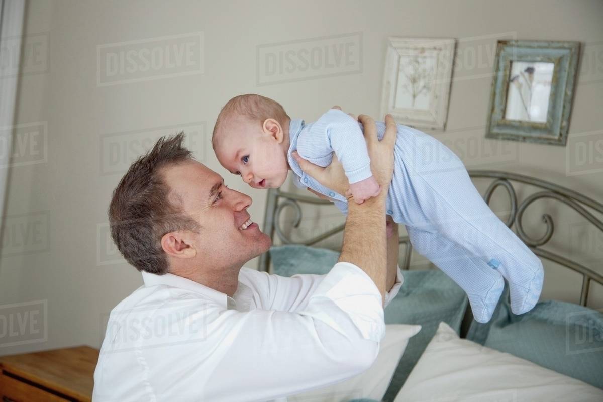 Father Playing With Baby - Stock Photo - Dissolve