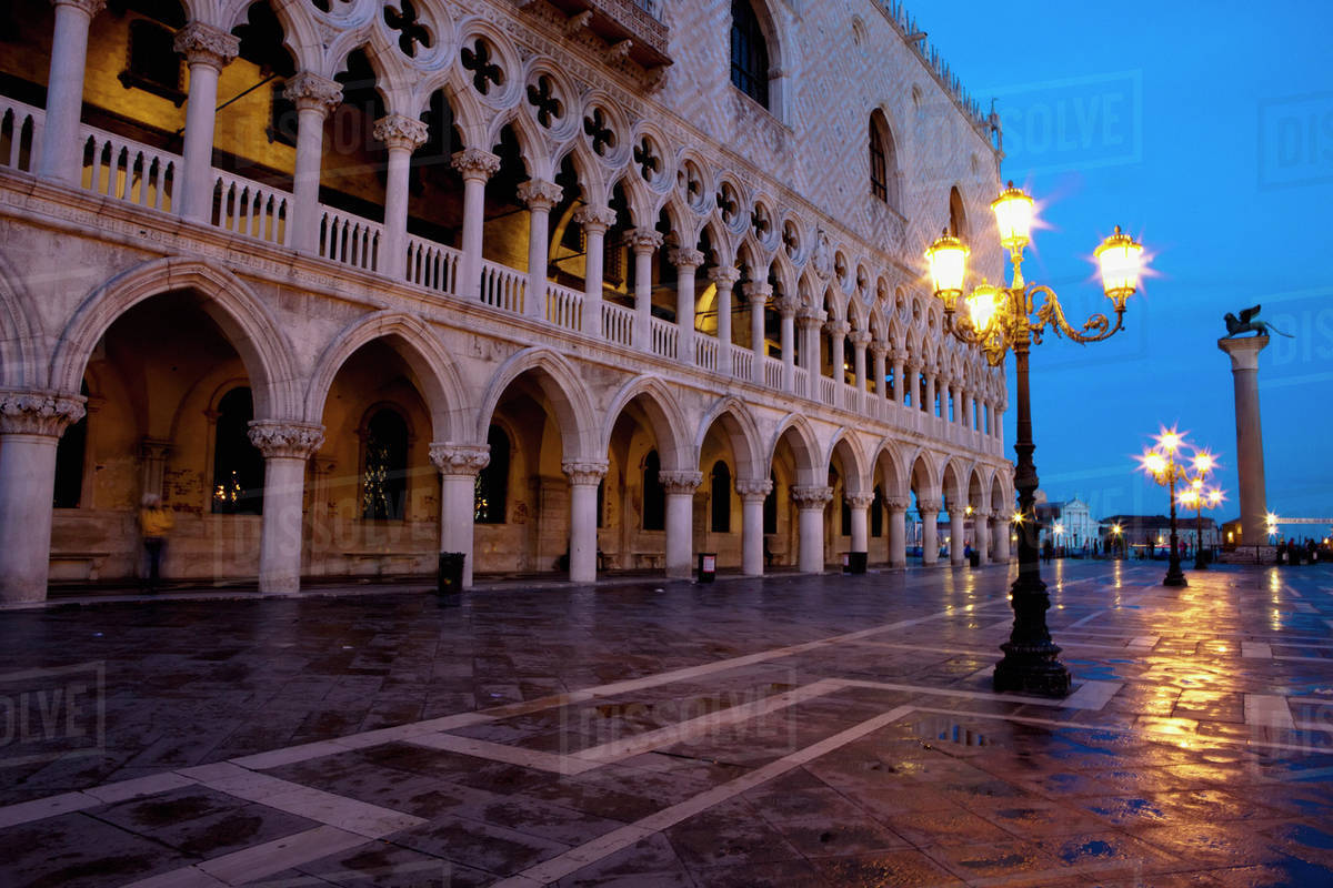 A Street Light Illuminated At Night In Front Of A Building; Venice ...