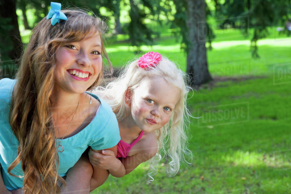 Two Sisters Playing Together In The Park Edmonton Alberta Canada