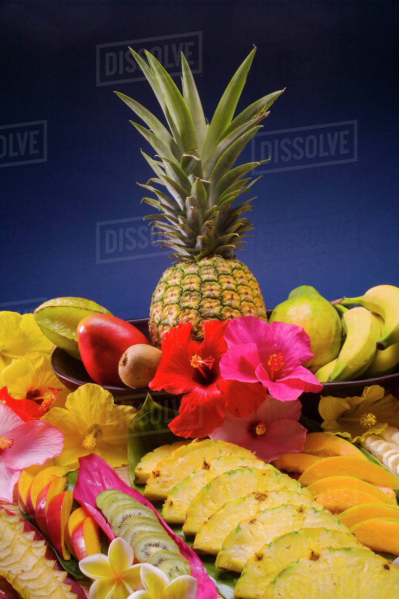Studio Shot Of A Variety Of Tropical Fruit, Whole And Cut Into Slices ...