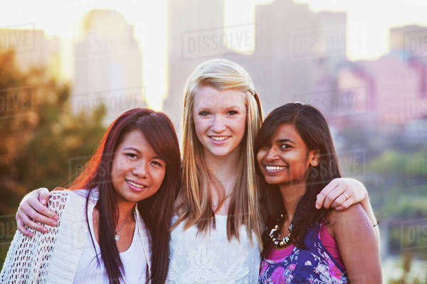 Portrait Of Three Friends With The City Skyline In The Background ...