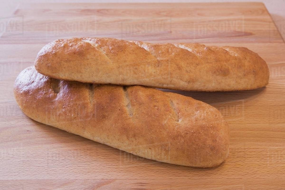 Two Loaves Of Baked Bread On A Cutting Board - Royalty-free Stock Photo ...
