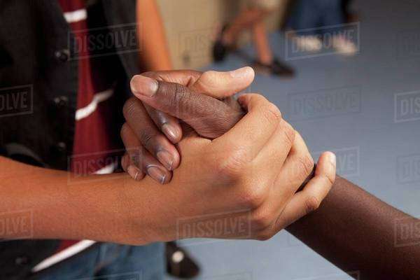 Two Hands Clasped - Stock Photo - Dissolve