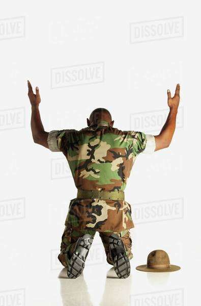A Military Man Kneeling With Hands Raised - Royalty-free Stock Photo ...