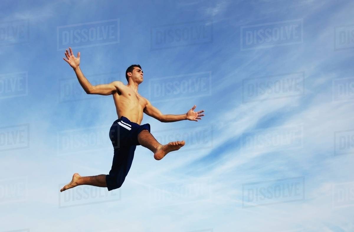 Young Man Jumping In The Air - Royalty-free Stock Photo | Dissolve