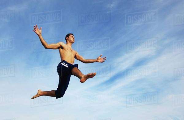 Young Man Jumping In The Air - Royalty-free Stock Photo | Dissolve