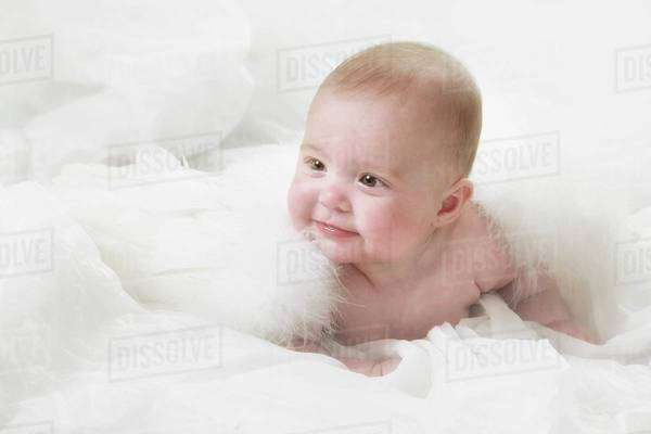 An Infant Laying In White Feathers - Royalty-free Stock Photo | Dissolve