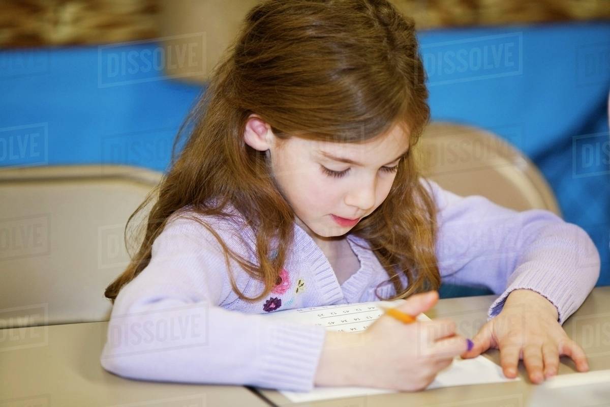 A Girl Writing On Paper At The Table - Royalty-free Stock Photo | Dissolve