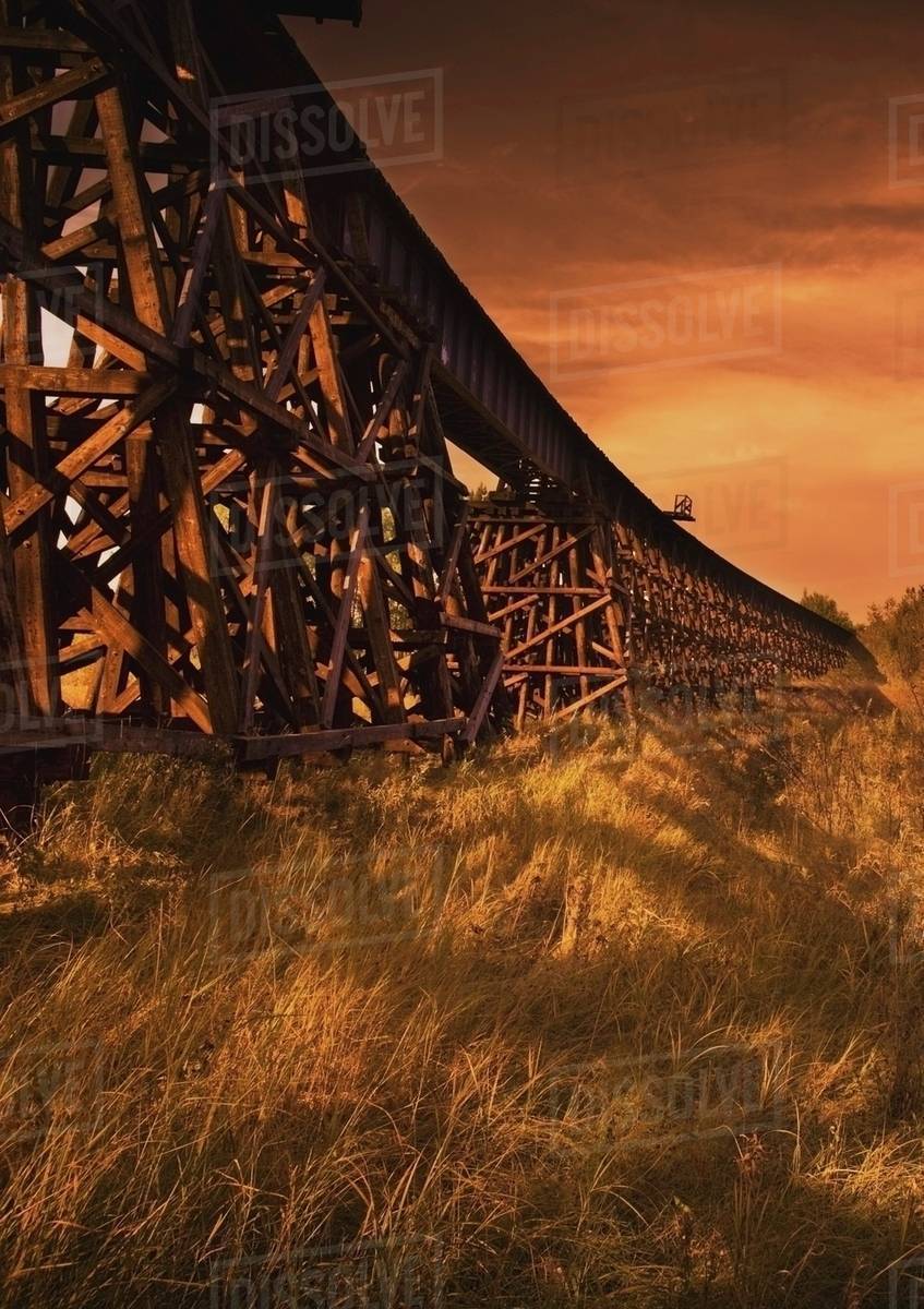 Alberta, Canada; A Train Trestle In A Sunset - Royalty-free Stock Photo ...