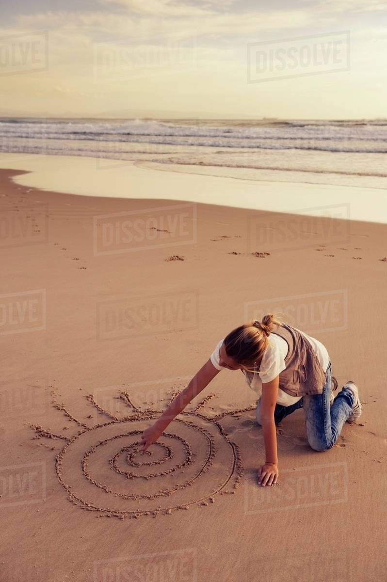 A Girl Drawing In The Sand At Los Lances Beach Along Costa De La Luz ...