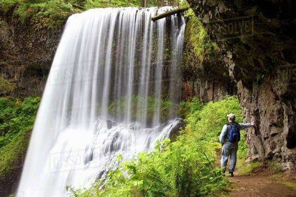 A Hiker At North Middle Falls In Silver Falls State Park; Oregon, Usa ...