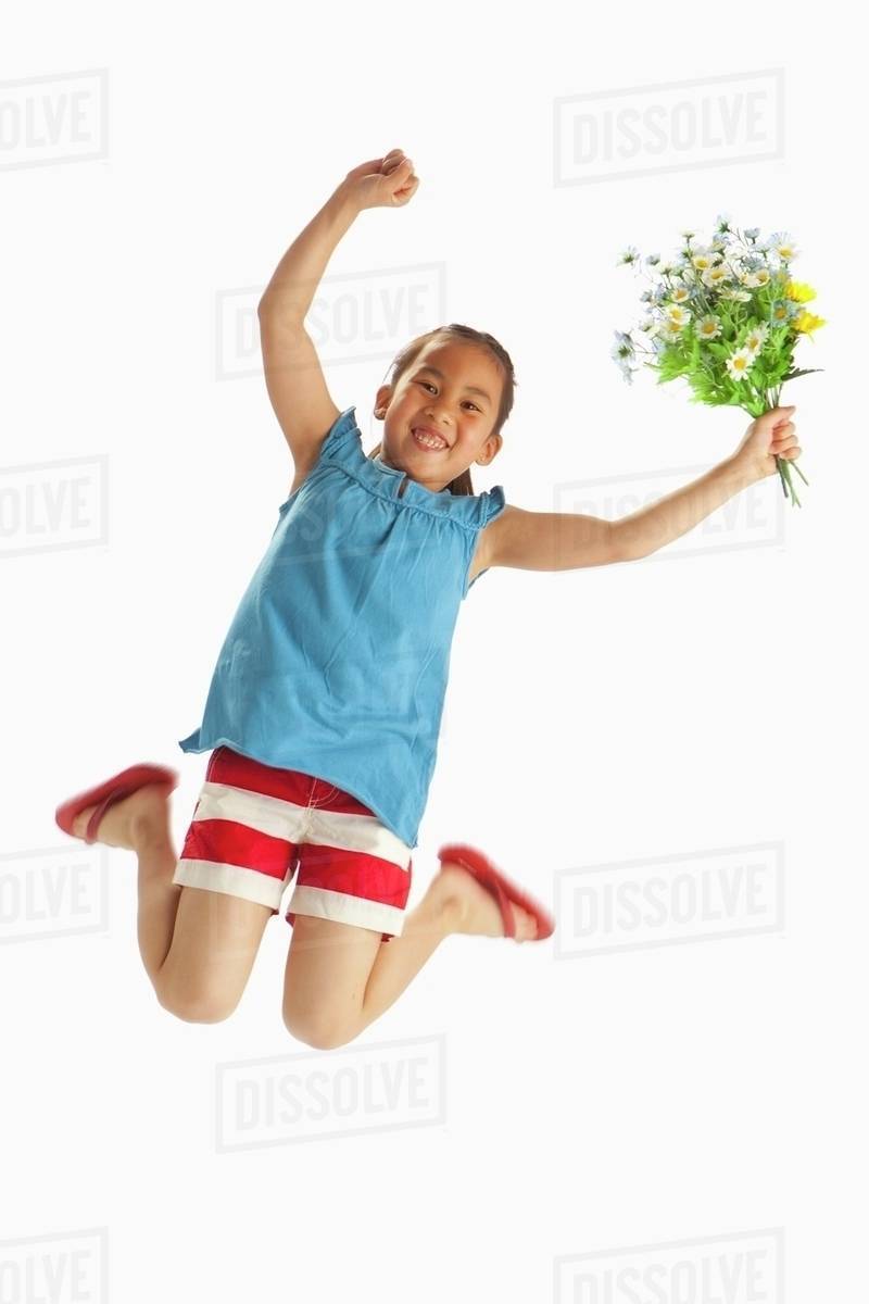 A Girl Jumps In The Air Holding A Bouquet Of Flowers; Three Hills ...