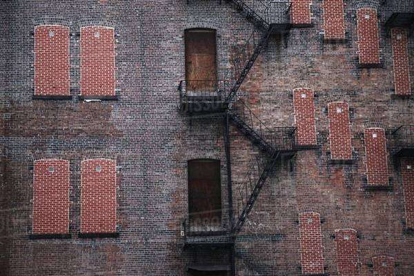 A Fire Escape Going Up The Side Of A Brick Building; Manhattan, New ...