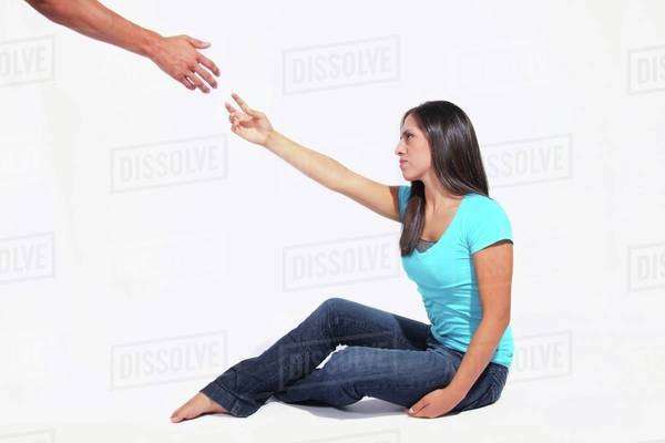 A Hand Reaching Out To Help A Woman Get Up - Stock Photo - Dissolve