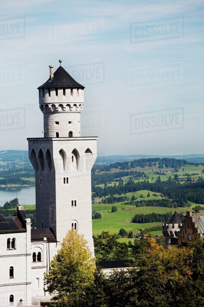 Turret Of A Bavarian Castle With Fields And A Lake In The Background ...