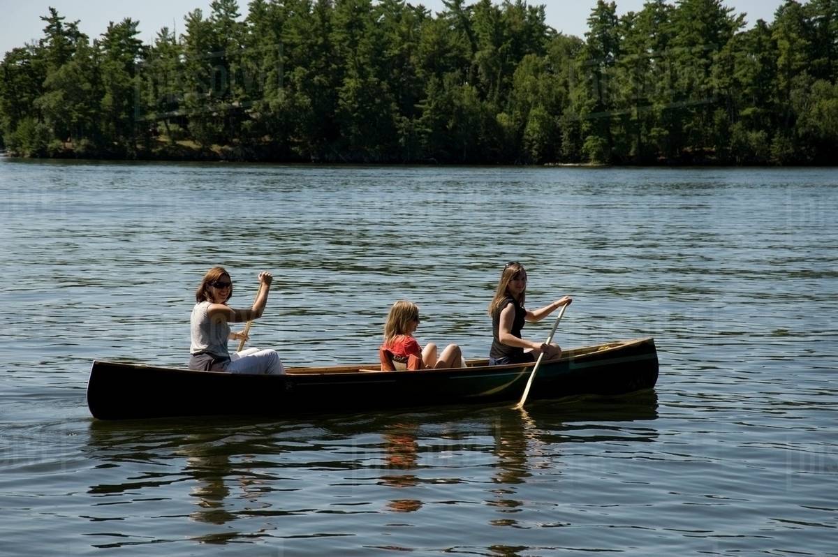 Three People Canoeing; Lake Of The Woods, Ontario, Canada - Royalty ...