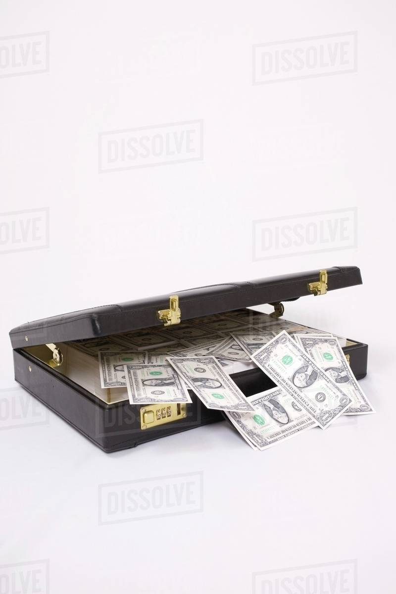 Briefcase With Money Spilling Out - Royalty-free Stock Photo | Dissolve