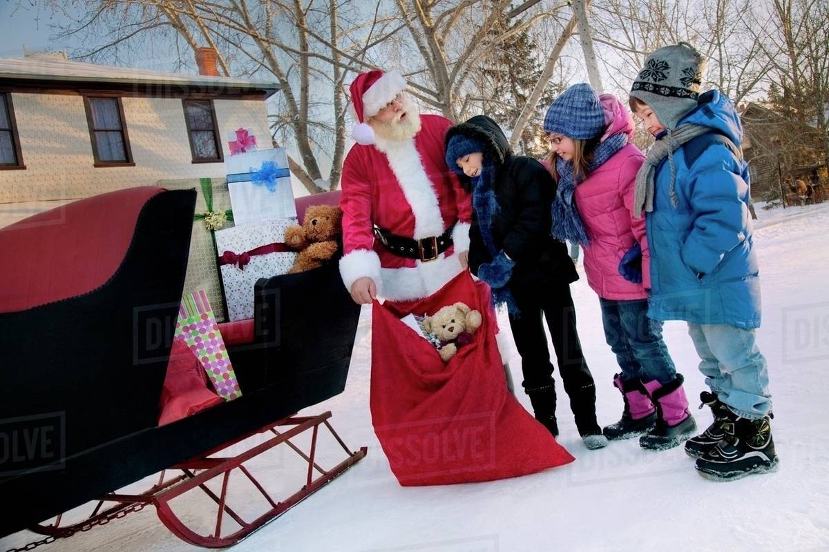 Santa Giving Gifts To Children - Royalty-free Stock Photo | Dissolve