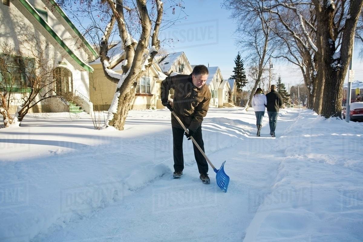 Man Shovelling Sidewalk - Royalty-free Stock Photo | Dissolve