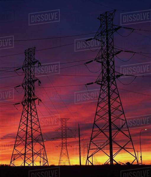 Electrical Towers At Sunrise - Stock Photo - Dissolve