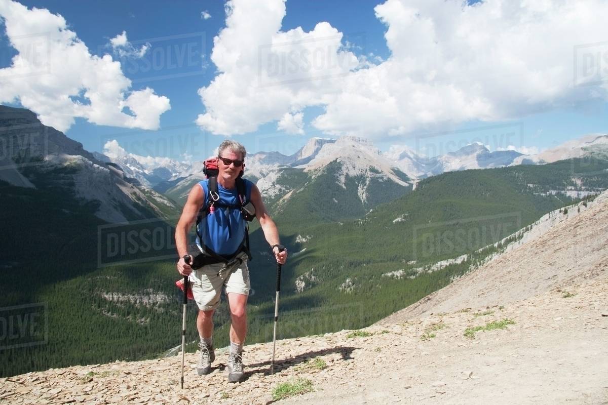 Man Walking On A Mountain Trail - Royalty-free Stock Photo | Dissolve