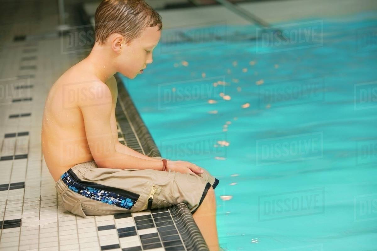 Boy Sitting On The Edge Of The Pool - Royalty-free Stock Photo | Dissolve