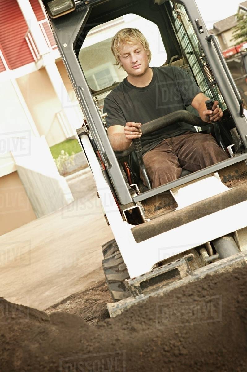 Man Operating A Skid Loader - Royalty-free Stock Photo | Dissolve