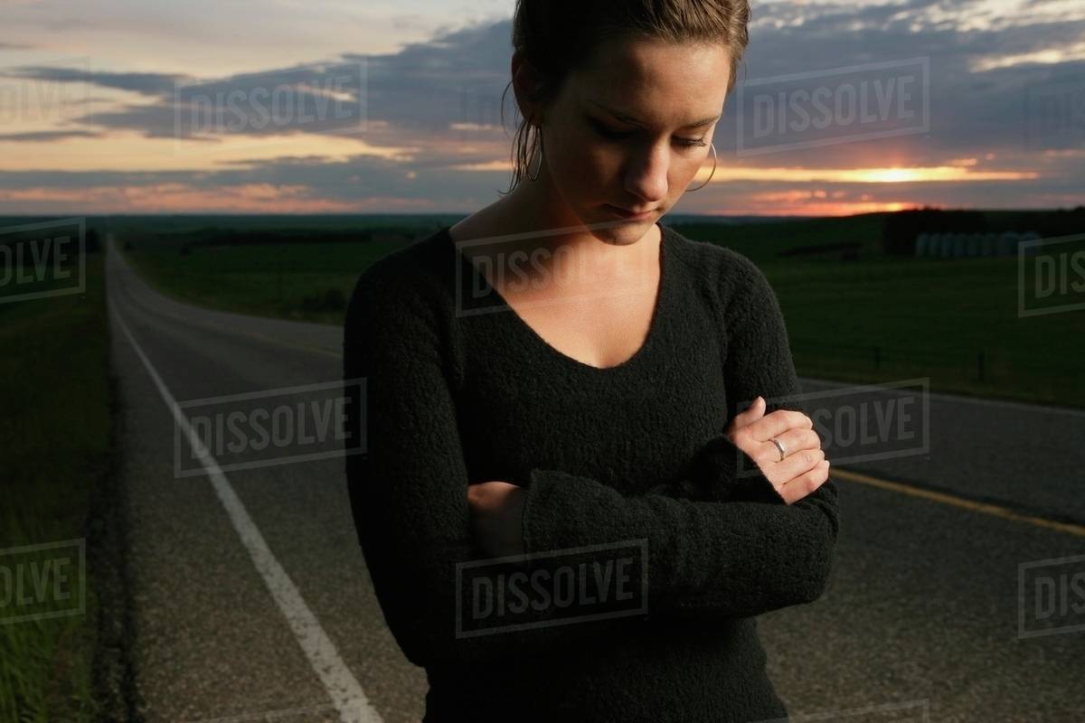 Sad Woman Beside The Road - Royalty-free Stock Photo | Dissolve