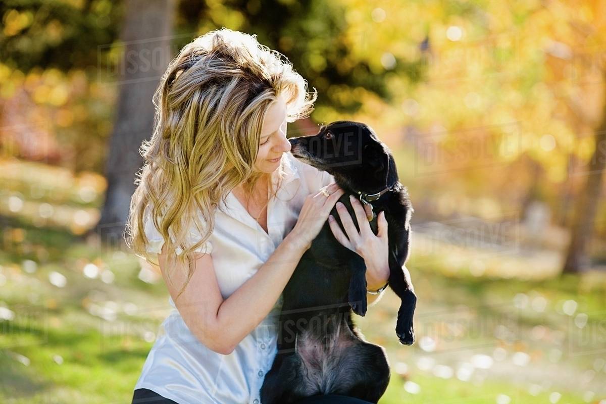 Woman Holding Dog - Royalty-free Stock Photo | Dissolve
