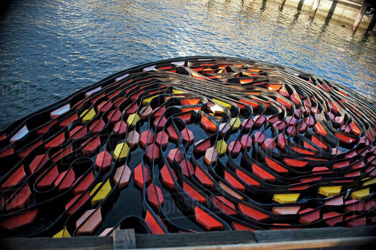A colorful coiled oil boom at the Seattle waterfront piers, Washington ...