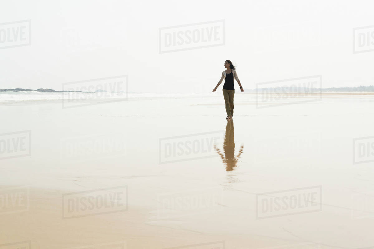 Young woman walking on the beach from HuoHu, North of Kinmen Island ...