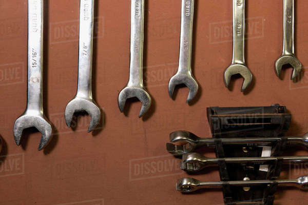 Detail of a set of wrenches hanging on a brown wall in a power plant ...