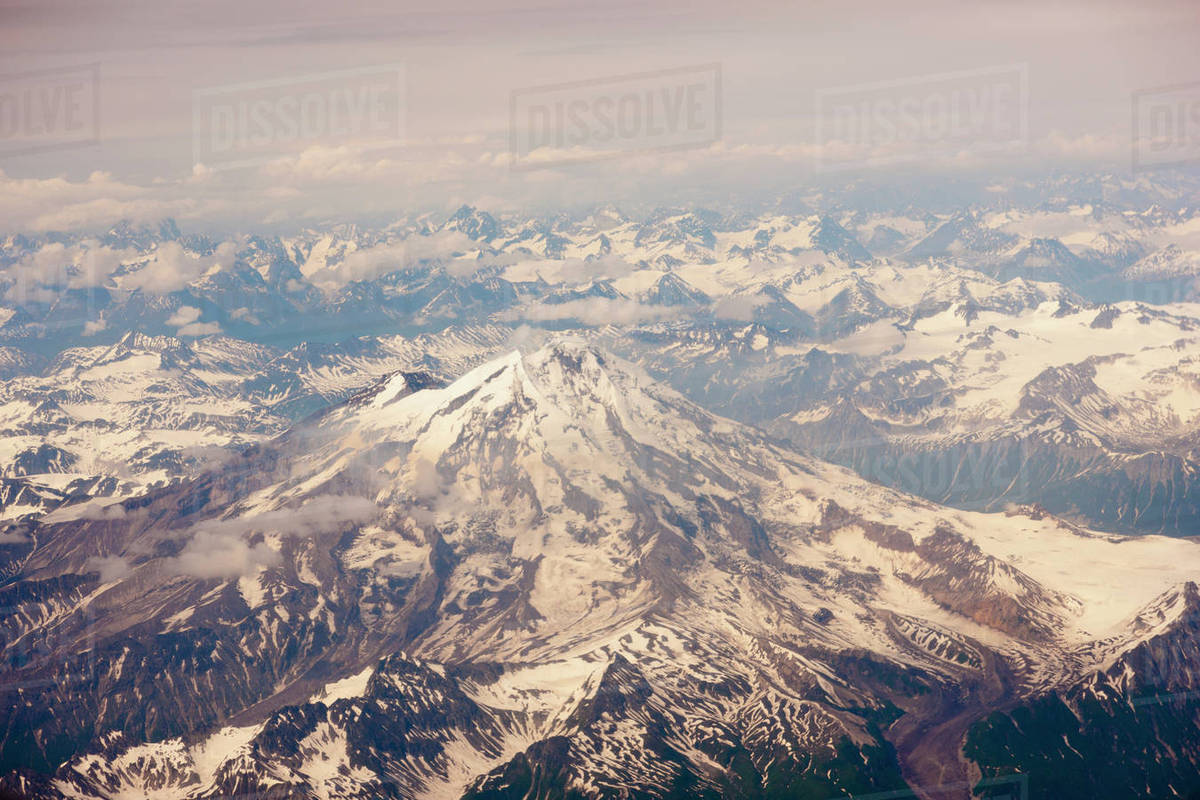 Aerial view of snow-covered Mt. Iliamna and surrounding mountains of ...