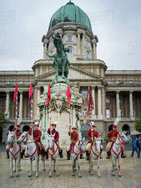 Horsemen dressed in red carrying flags at Buda Castle in Buda's Castle ...
