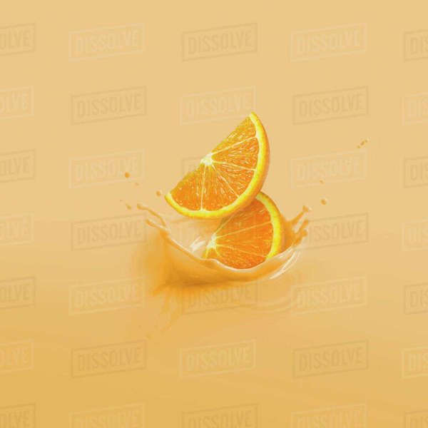 Orange Slices Splashing Into Orange Liquid; Toronto, Ontario, Canada ...