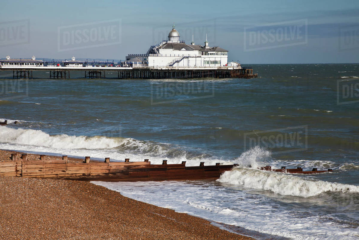 Eastbourne Pier With Breaking Waves, Groyne And Beach; Sussex, England ...