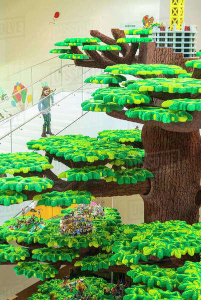 Girl looking over giant Lego tree in the Lego House; Billund, Denmark ...