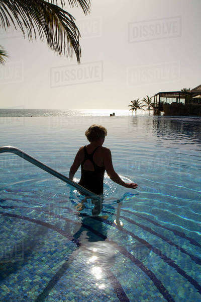 Person in swimming pool - Stock Photo - Dissolve