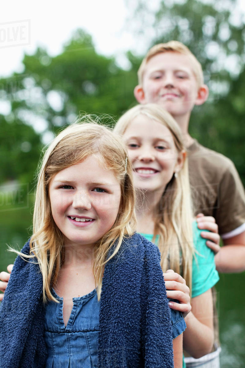 Cheerful siblings in a row - Royalty-free Stock Photo | Dissolve