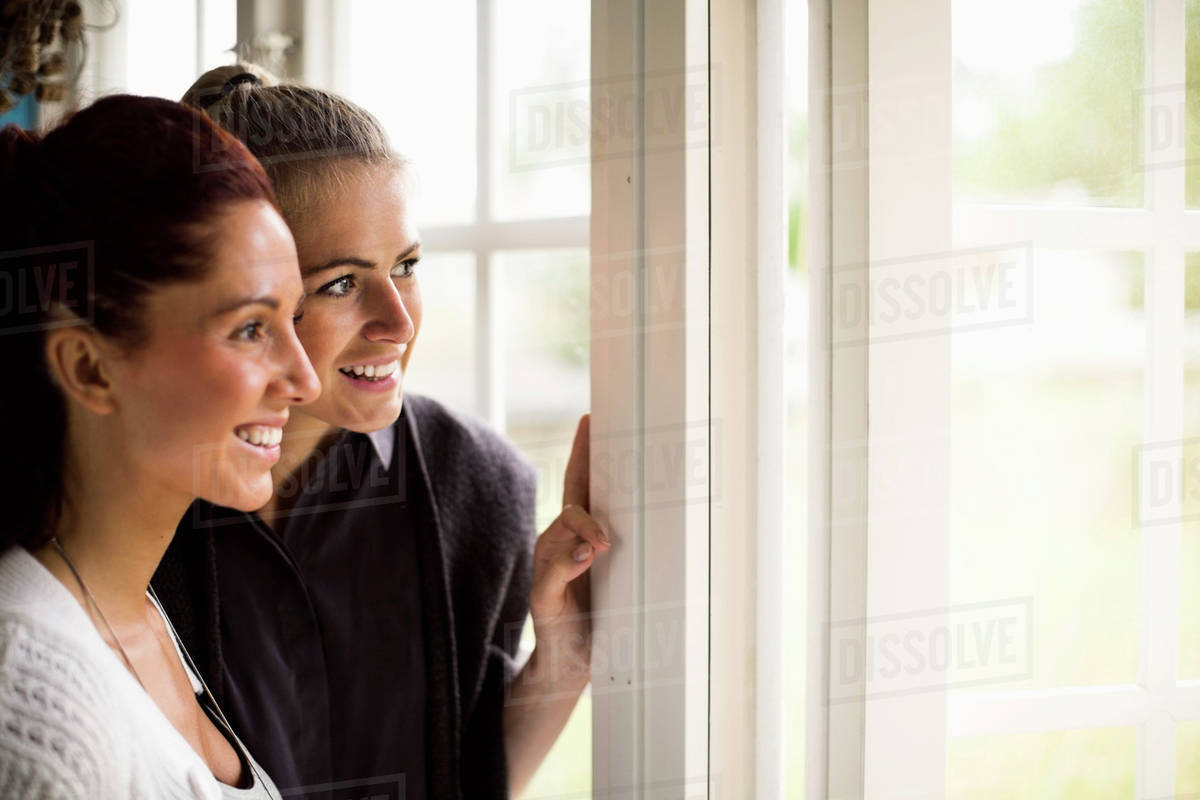 Women looking out through window of summer house - Royalty-free Stock ...
