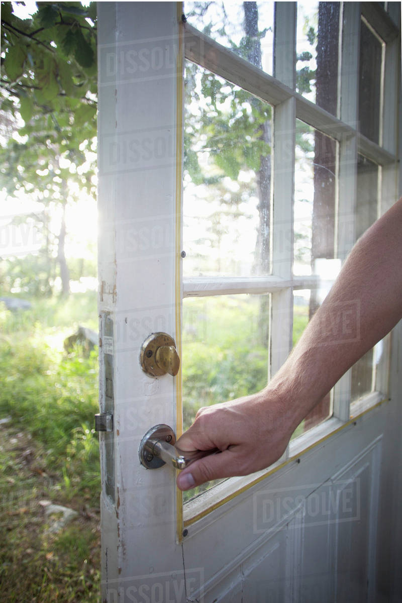 Cropped image of man holding door handle - Royalty-free Stock Photo ...