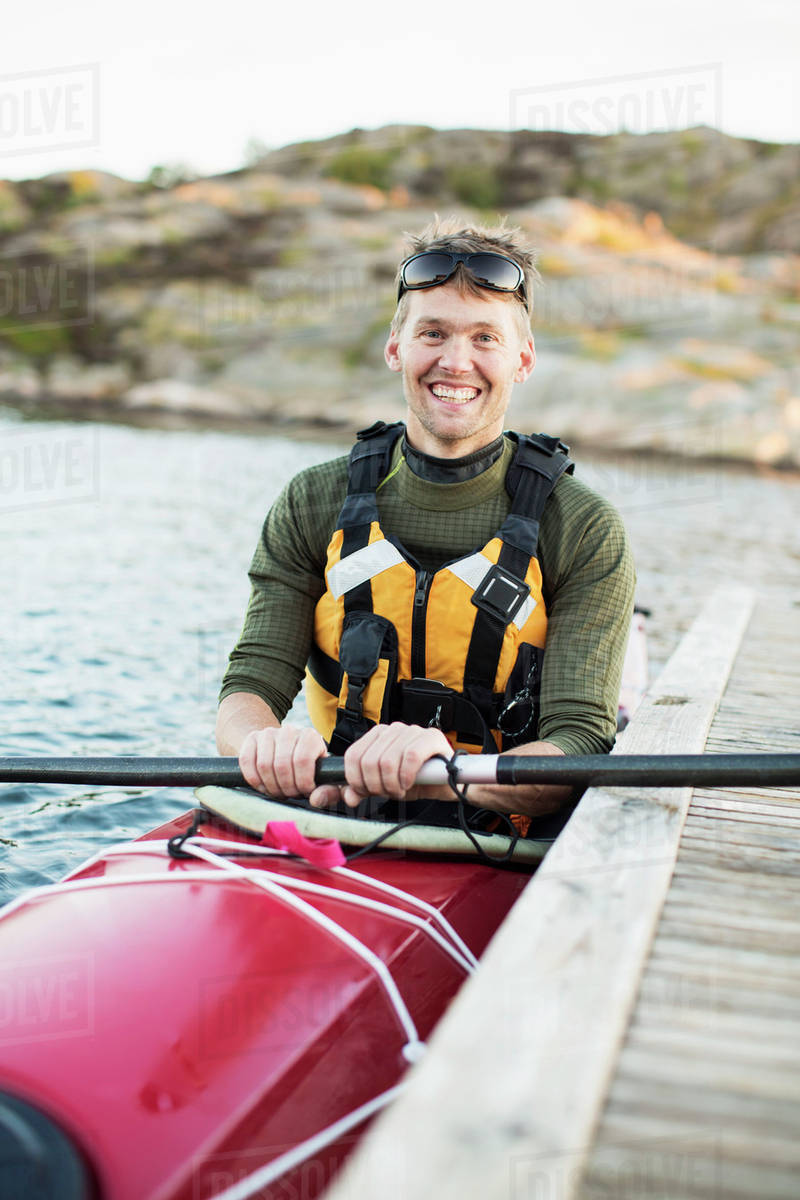 Portrait of happy man kayaking in river - Stock Photo - Dissolve