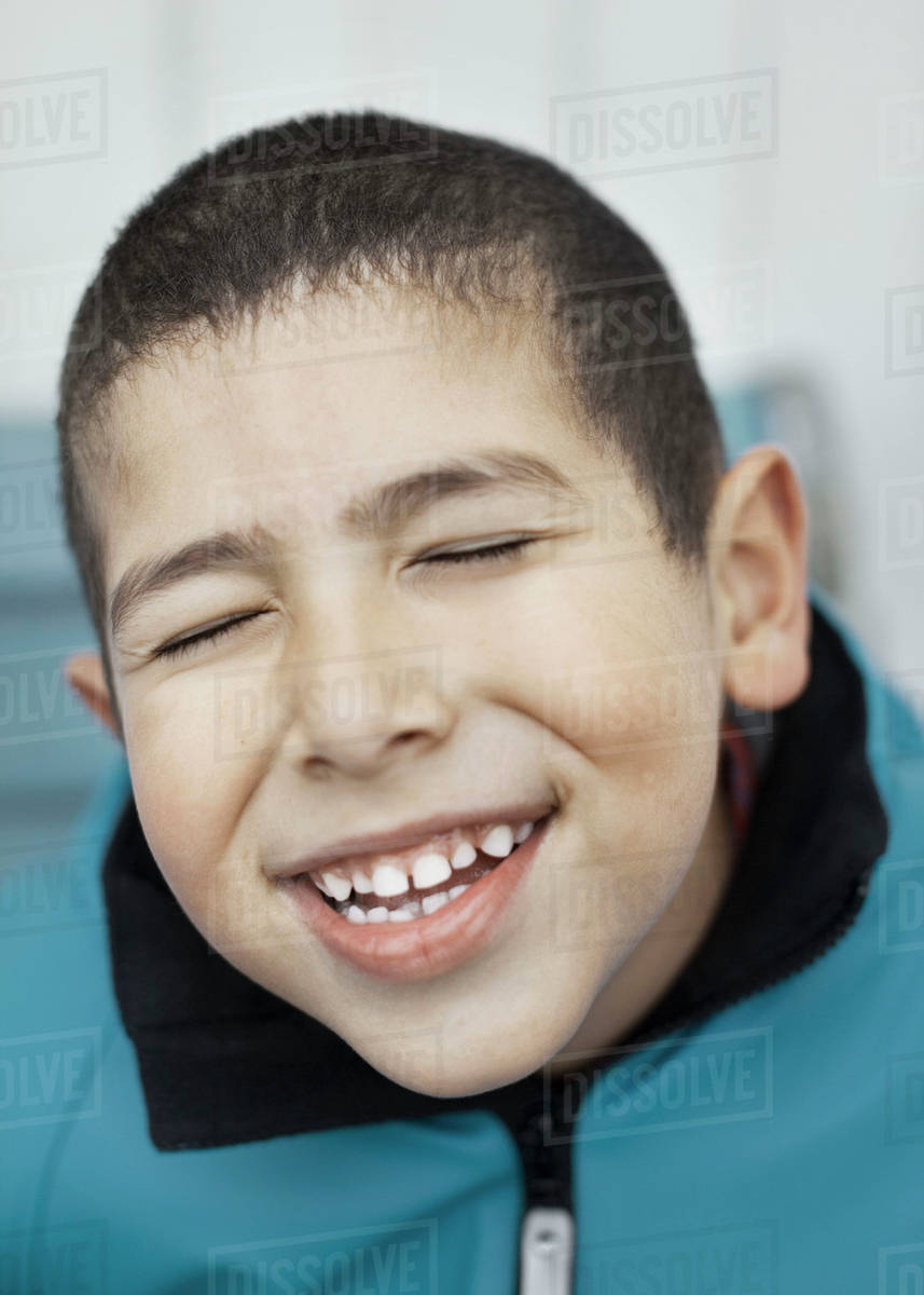 Smiling boy with eyes closed outdoors - Stock Photo - Dissolve