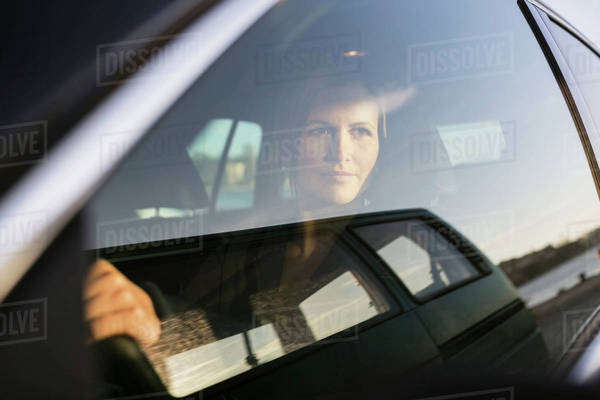 Businesswoman looking through window while driving car - Stock Photo ...