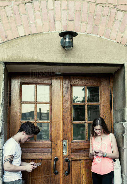 Students waiting outside entrance of high school building - Stock Photo ...