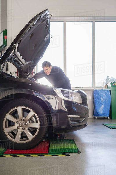 Mechanic repairing car in auto repair shop - Royalty-free Stock Photo ...