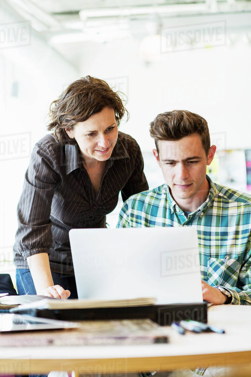 Professor and student talking in classroom - Stock Photo - Dissolve