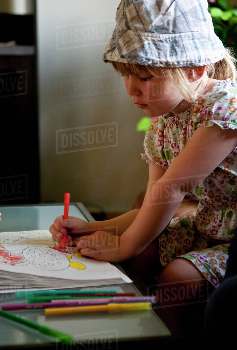 Little adorable girl drawing on paper - Royalty-free Stock Photo | Dissolve