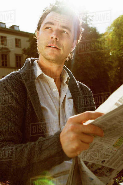 Man holding newspaper - Royalty-free Stock Photo | Dissolve