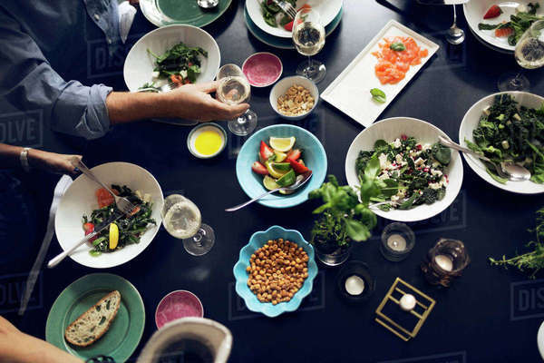 Cropped image of friends eating food at table - Royalty-free Stock ...